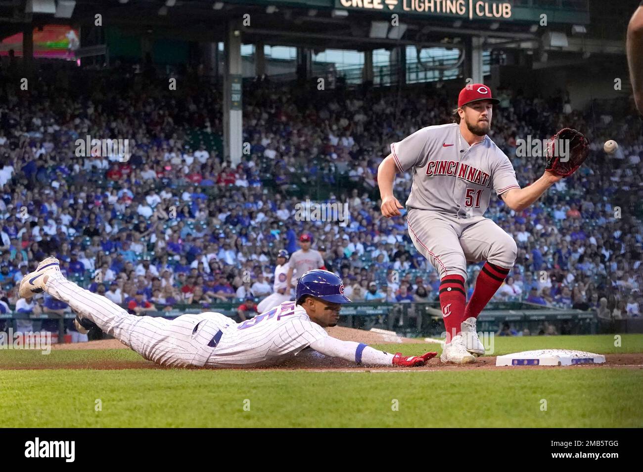 Chicago Cubs' Christopher Morel dives safely in to first on an infield ...
