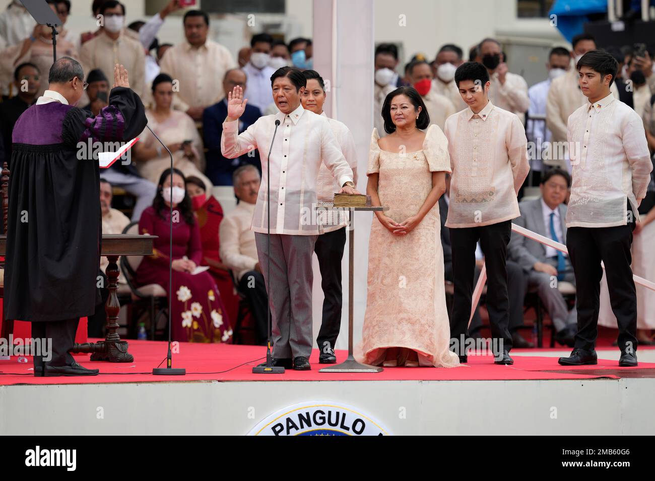 President-elect Ferdinand Marcos Jr., second from left, is sworn in by ...