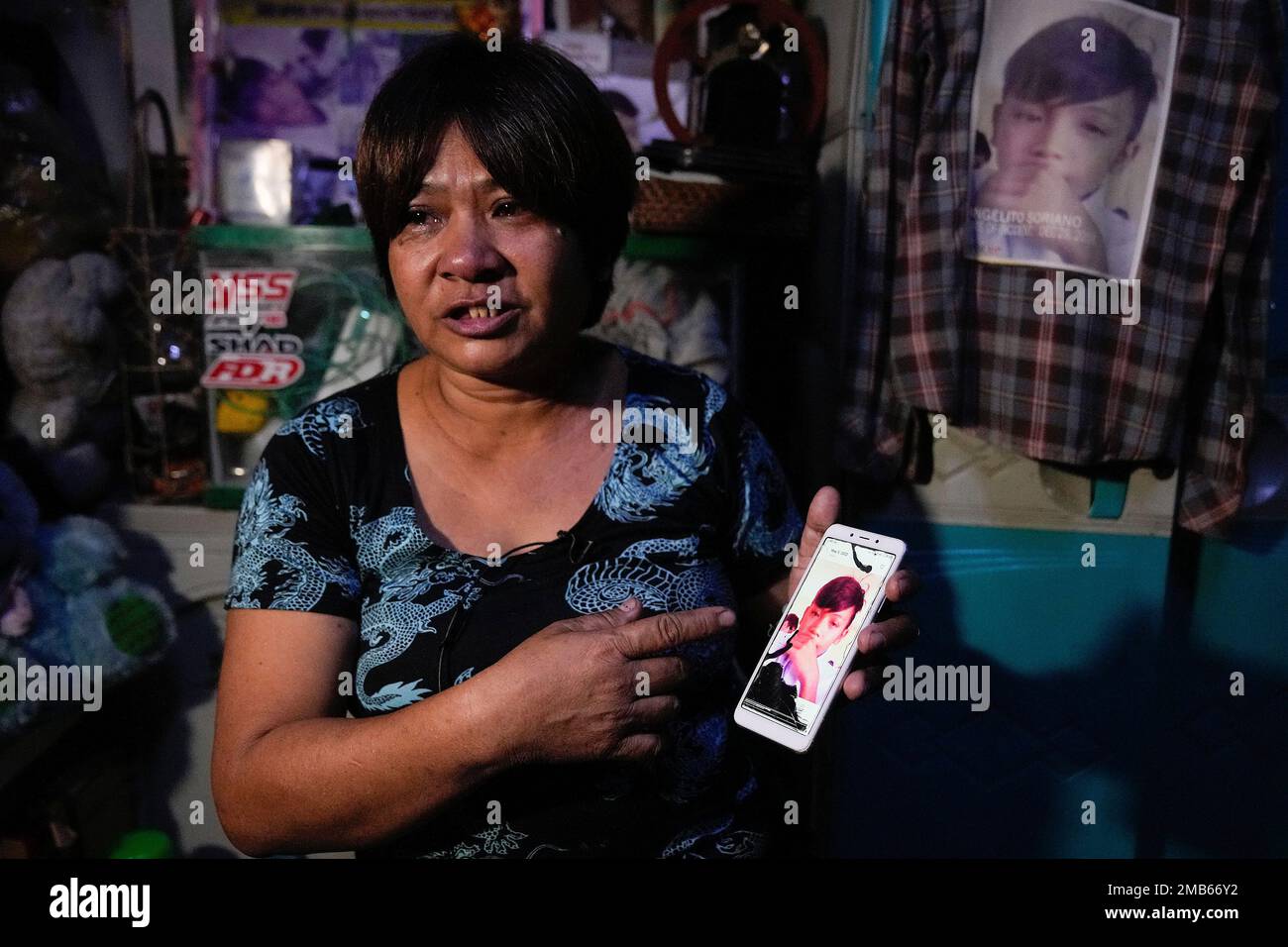 Emily Soriano shows a picture of her 15-year-old son on her smartphone ...