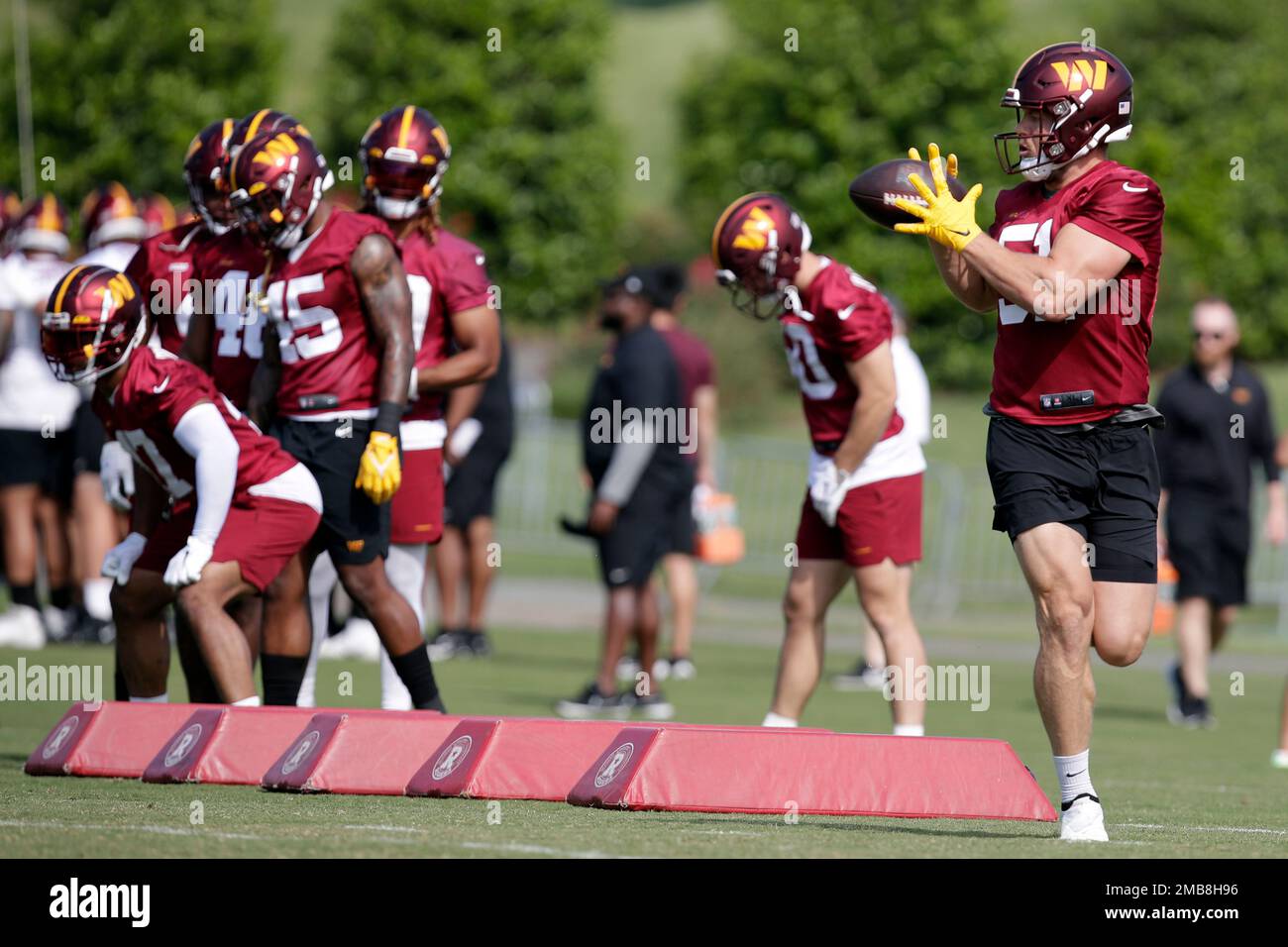 Washington Commanders linebacker David Mayo, right, catches the ball ...