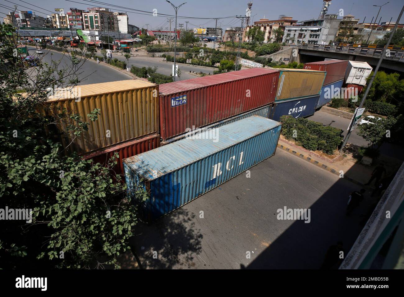 Shipping containers placed by authorities block a key highway to ...