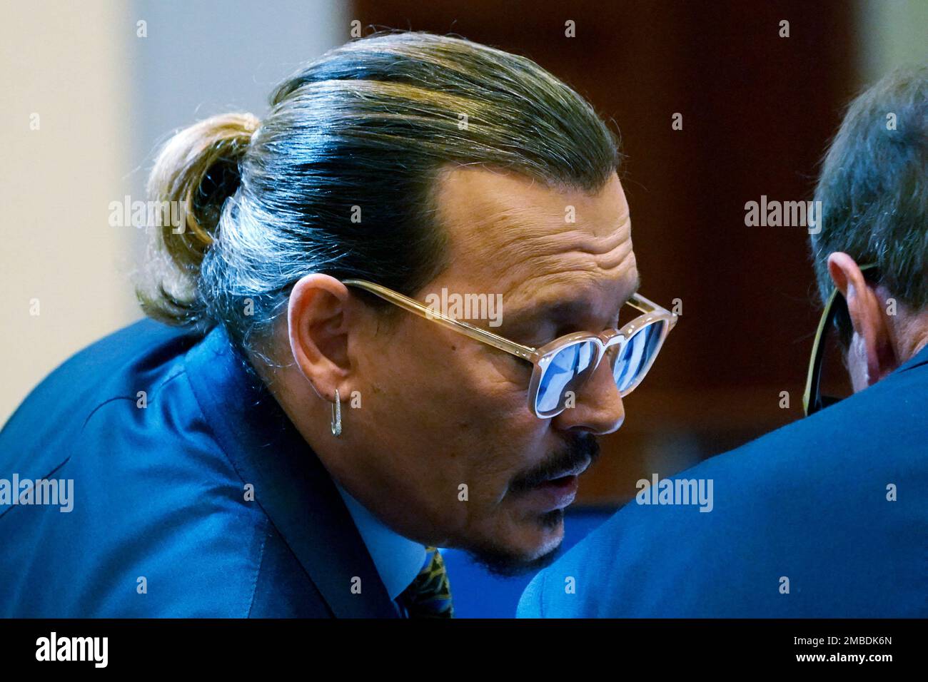 Actor Johnny Depp talks to his attorney Ben Chew, in the courtroom at ...