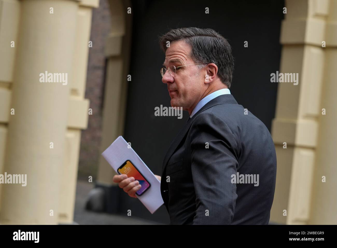 Dutch Prime Minister Mark Rutte holds his smartphone as he gets out of ...