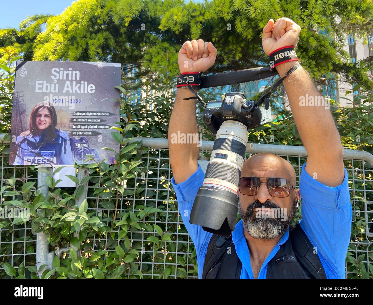 Ibrahim Almasri, an Egyptian freelance photographer, wraps his camera straps around his wrists ...