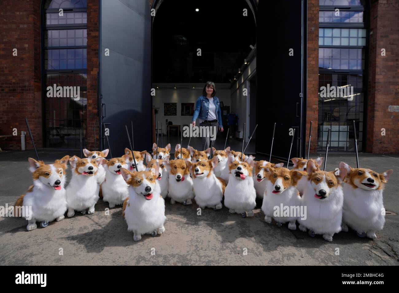 Puppet maker Louise Jones stands with her group of corgi puppets, each ...