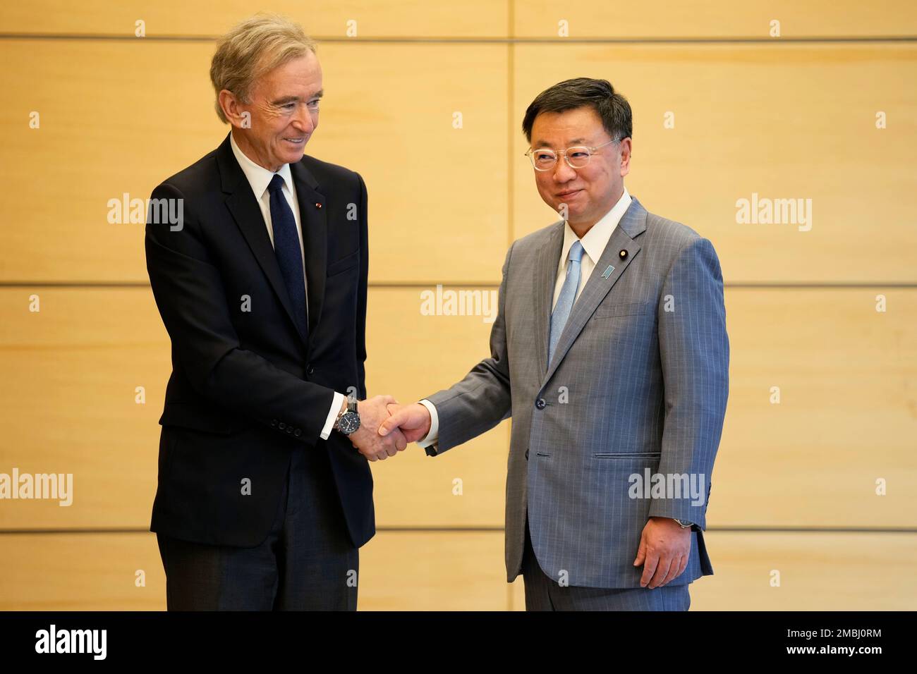 LVMH CEO Bernard Arnault, left, and Japanese Chief Cabinet Secretary ...