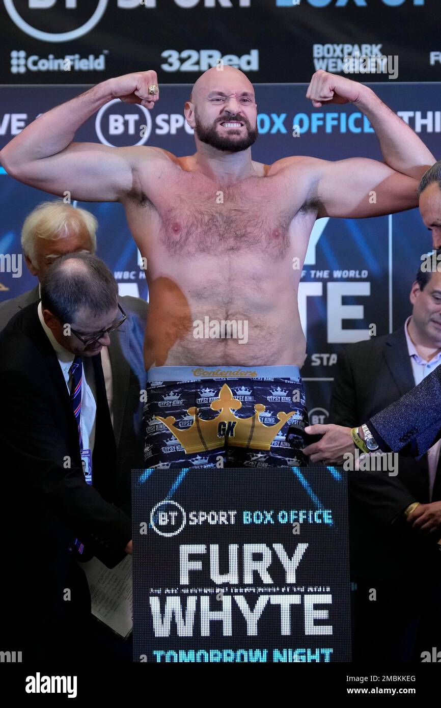 British heavyweight boxer Tyson Fury shows his muscles during weigh-in ...