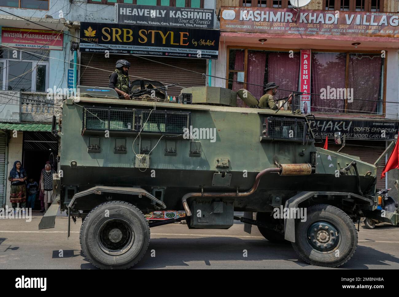 Indian paramilitary soldiers guard atop of their armored vehicle near ...
