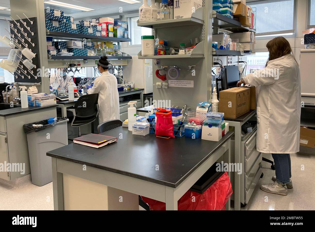 Graduate program students Emma Lancaster, right, Emily Lu, center, and ...