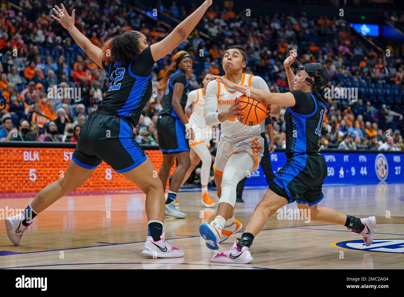 Tennessee's Brooklynn Miles, center, loses the ball as she drives ...
