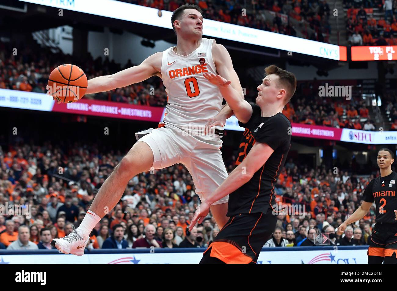 Syracuse forward Jimmy Boeheim, left, looks to pass as Miami forward ...