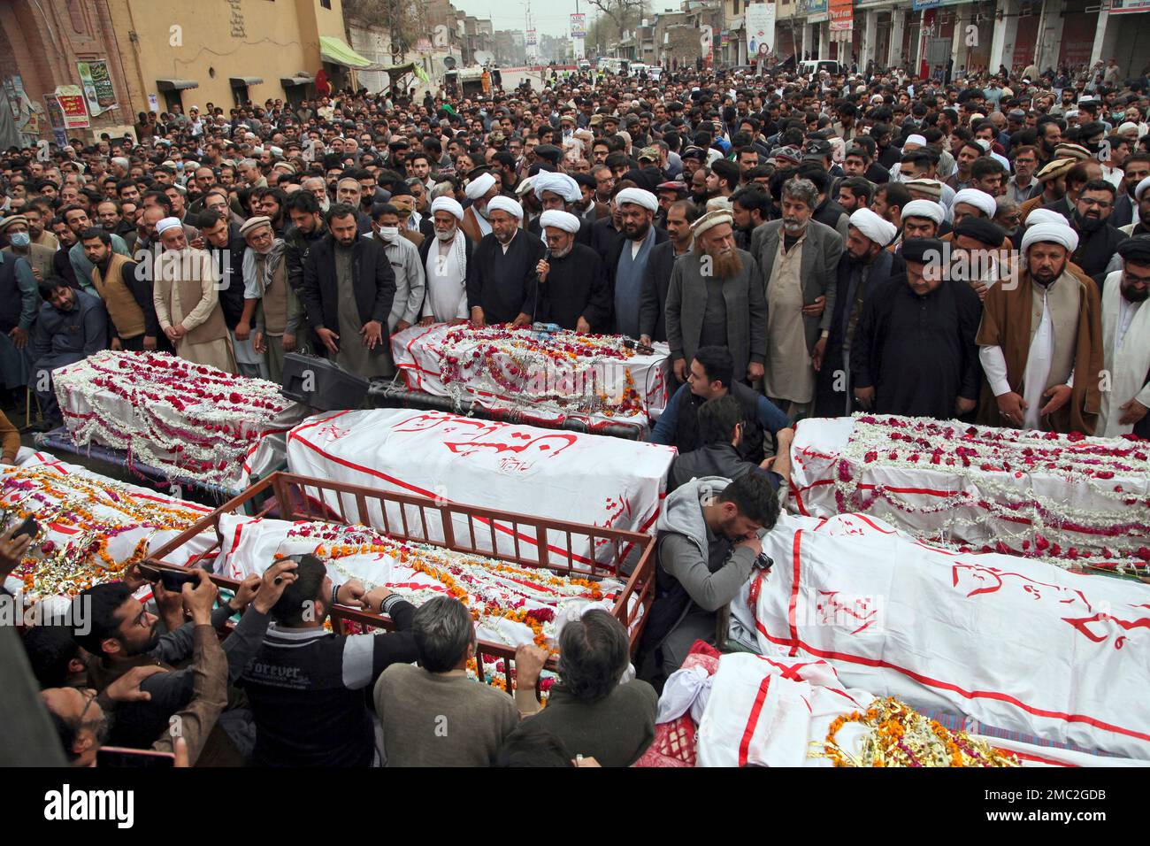 People attend the funeral prayers for the victims of Friday's suicide ...