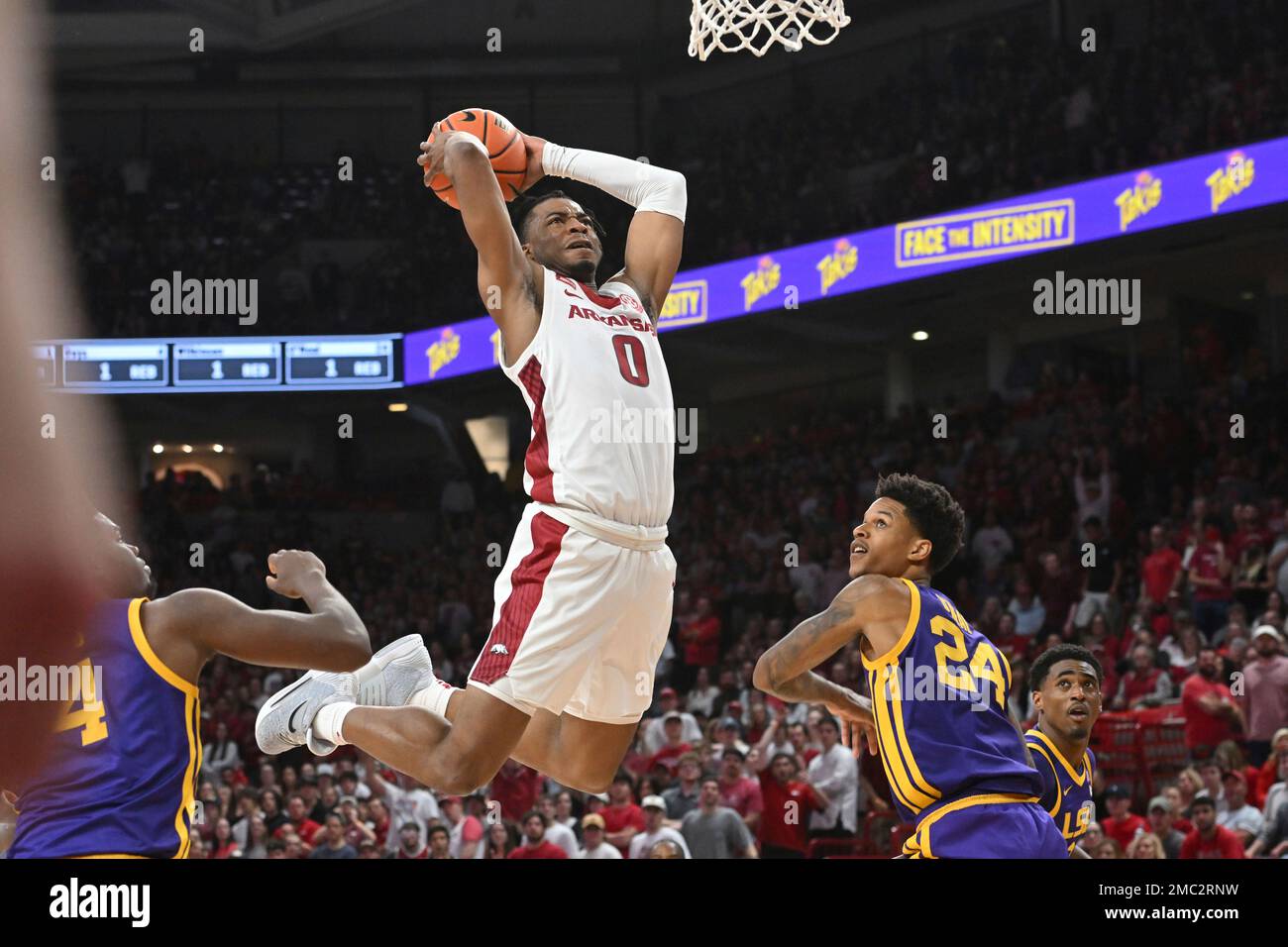 Arkansas guard Stanley Umude (0) drives past LSU defenders Darius Days ...