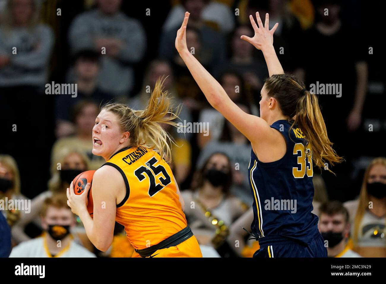 Iowa forward Monika Czinano (25) drives around Michigan forward Emily ...