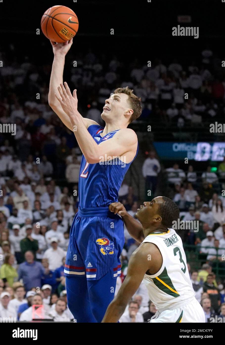 Kansas guard Christian Braun shoots next to Baylor guard Dale Bonner ...