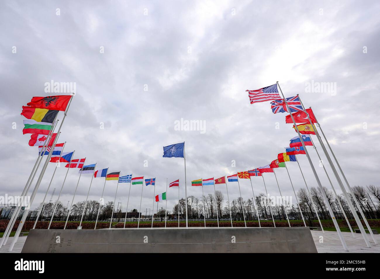 Flags of NATO member countries flap in the wind outside NATO ...