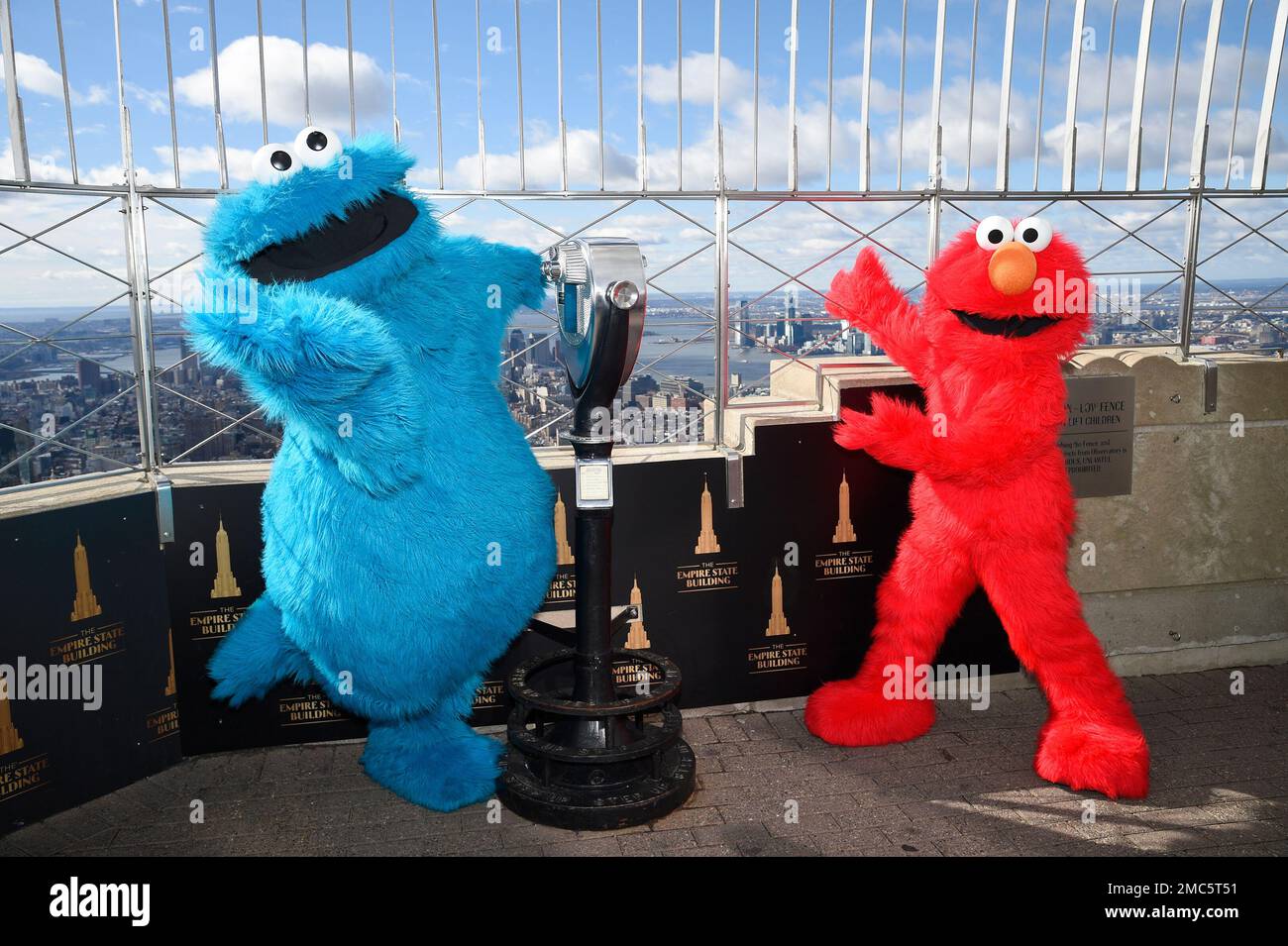 Sesame Street characters Cookie Monster, left, and Elmo pose on the ...