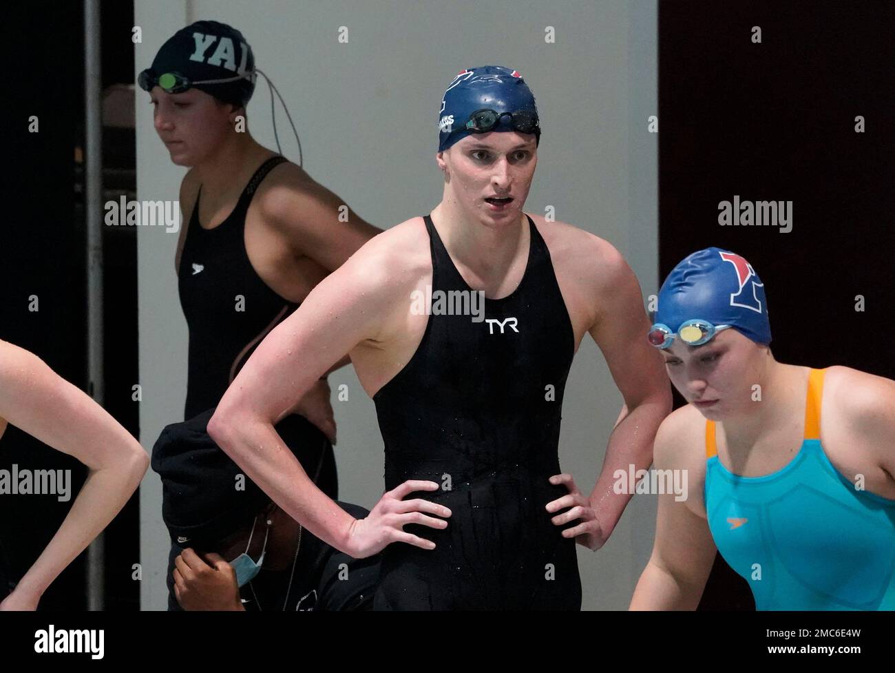 Penn's Lia Thomas, center, reacts after swimming the first leg of the ...