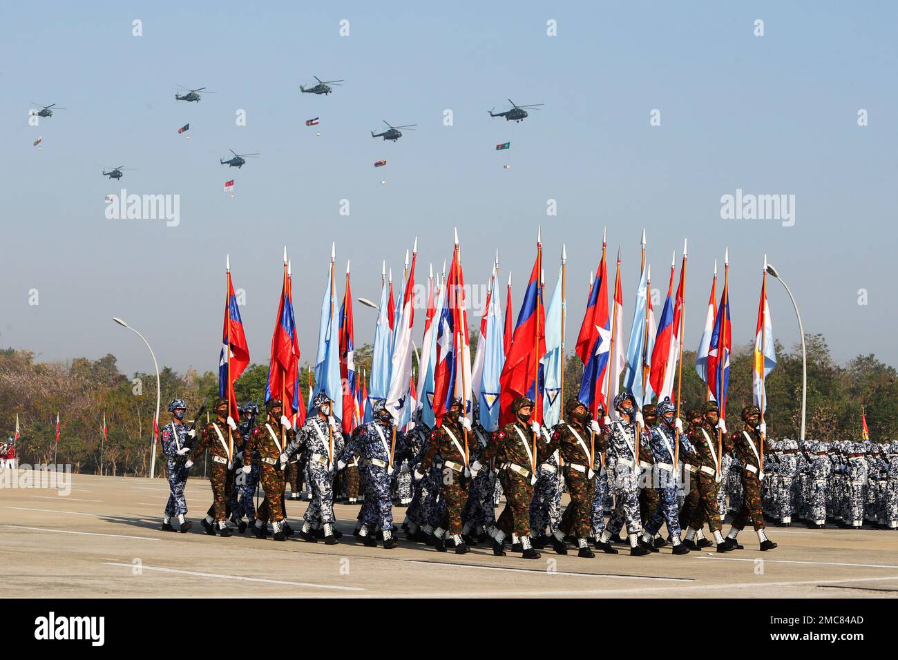 Myanmar military officers march while military fighter planes fly over ...