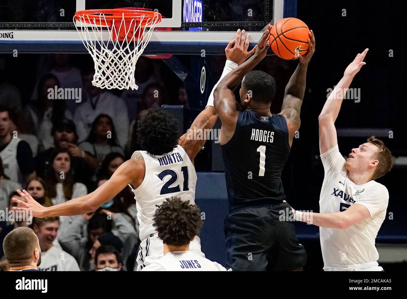 Butler guard Bo Hodges (1) shoots over Xavier's Jerome Hunter (21) and ...