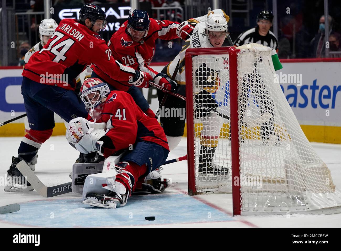 Washington Capitals goaltender Vitek Vanecek, front left, makes a save ...