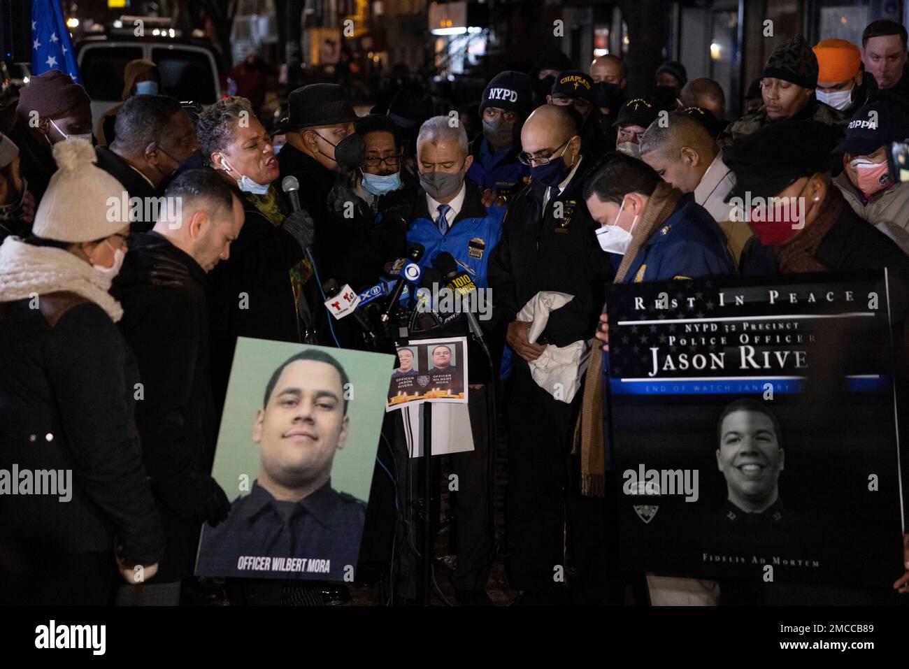 People pray during a candlelight vigil outside the New York City Police ...