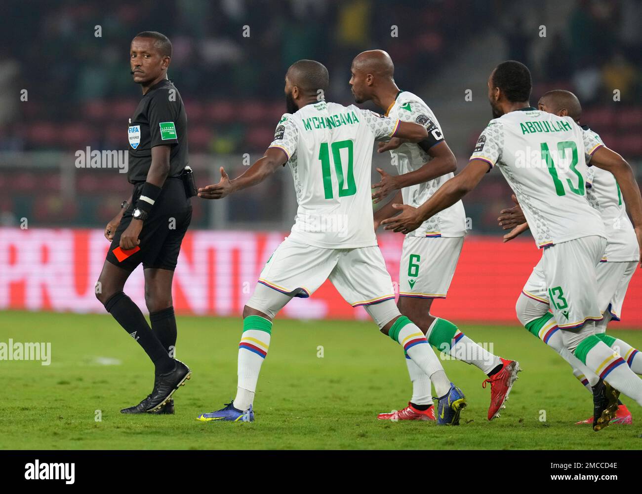 Referee Bamlak Tessema of Ethiopia, left, prepares to show a red card ...