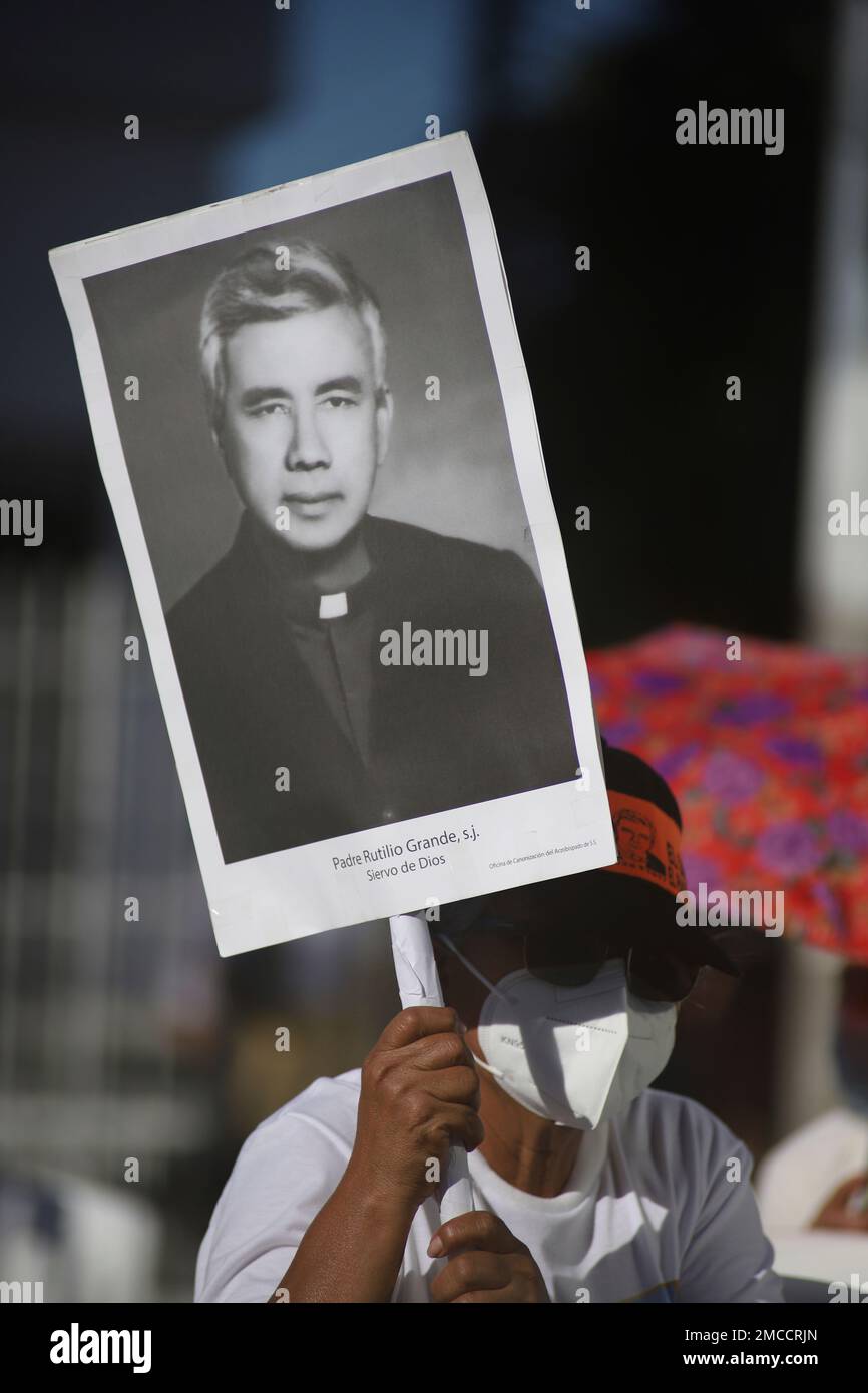 A woman holds a poster depicting the Rev. Rutilio Grande, during his ...