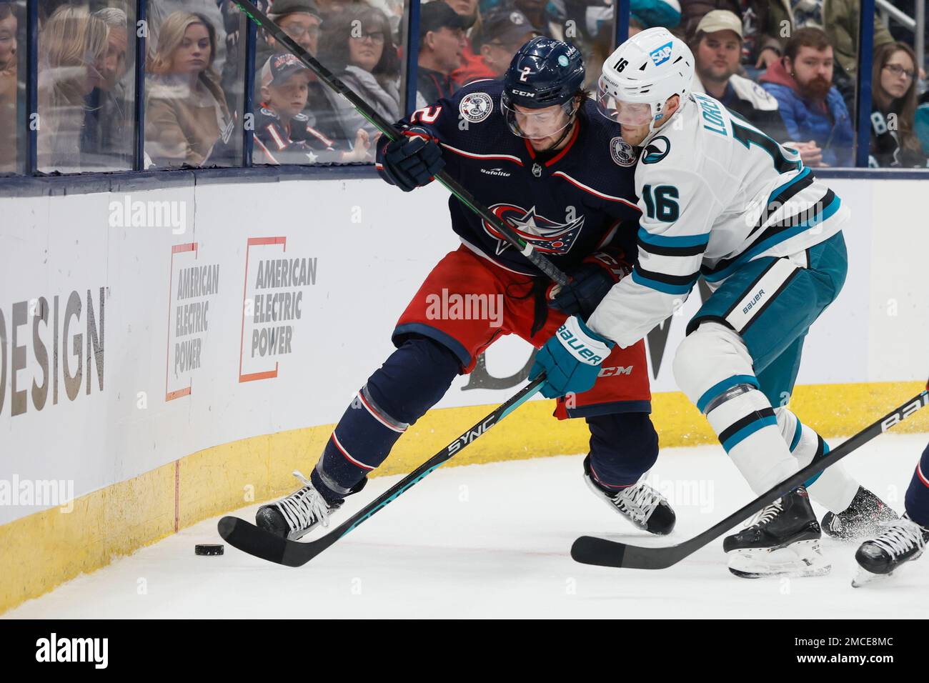Columbus Blue Jackets' Andrew Peeke, left, and San Jose Sharks' Steven ...