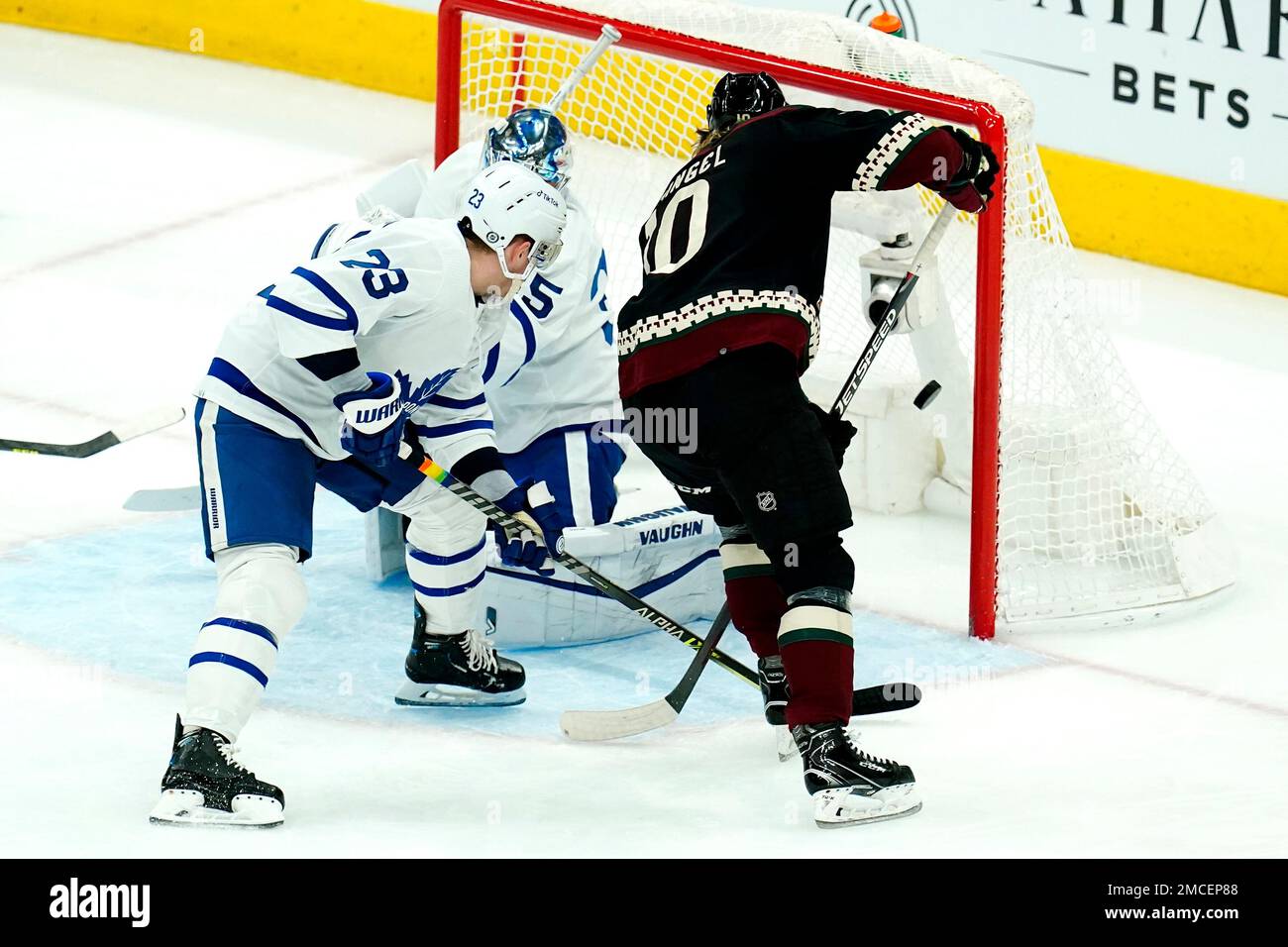 Arizona Coyotes center Ryan Dzingel, right, scores a goal against ...