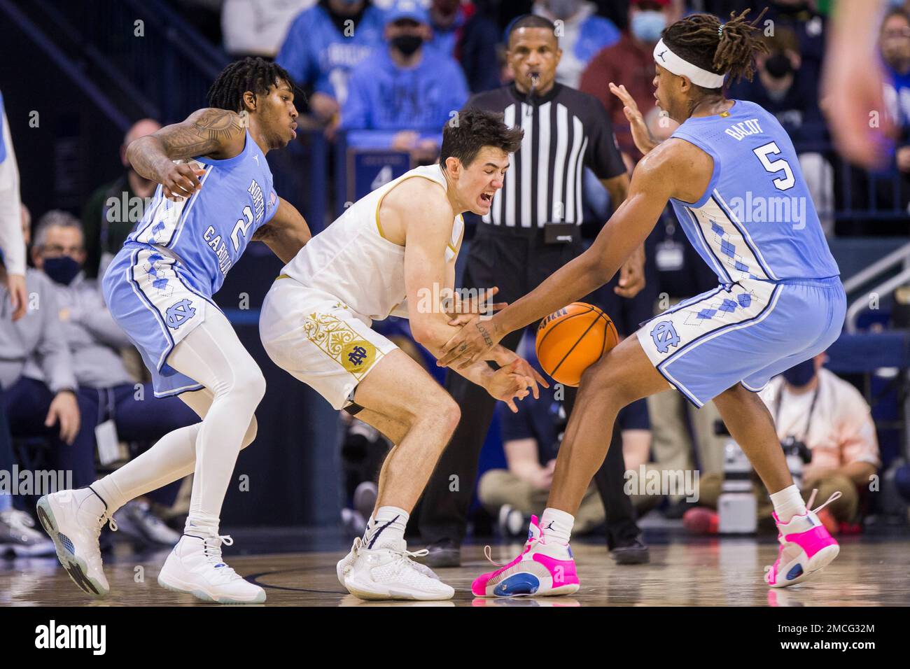 Notre Dame's Cormac Ryan, center, has the ball knocked away as he gets ...