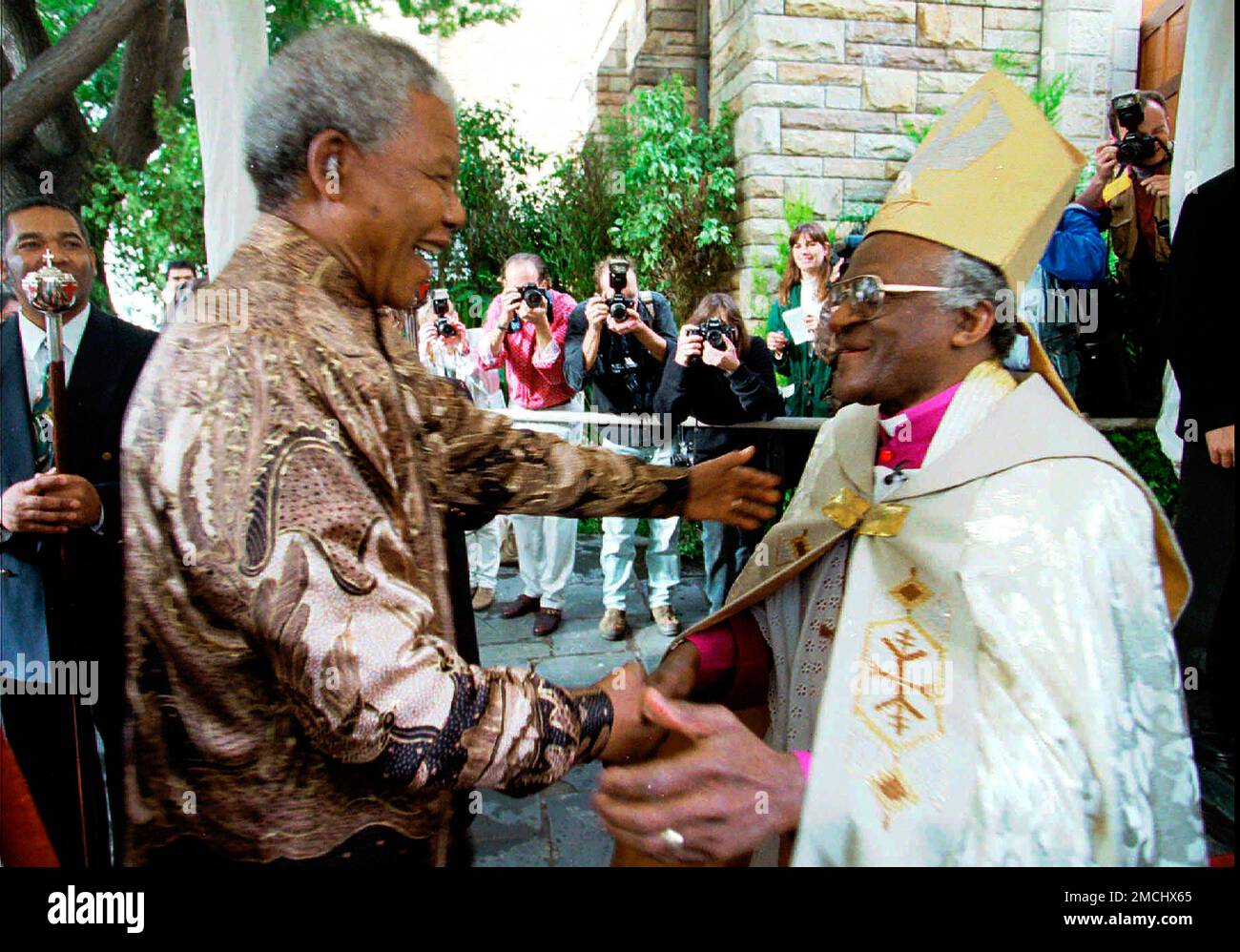 FILE - Retiring Archbishop of Cape Town Desmond Tutu, right, greets ...