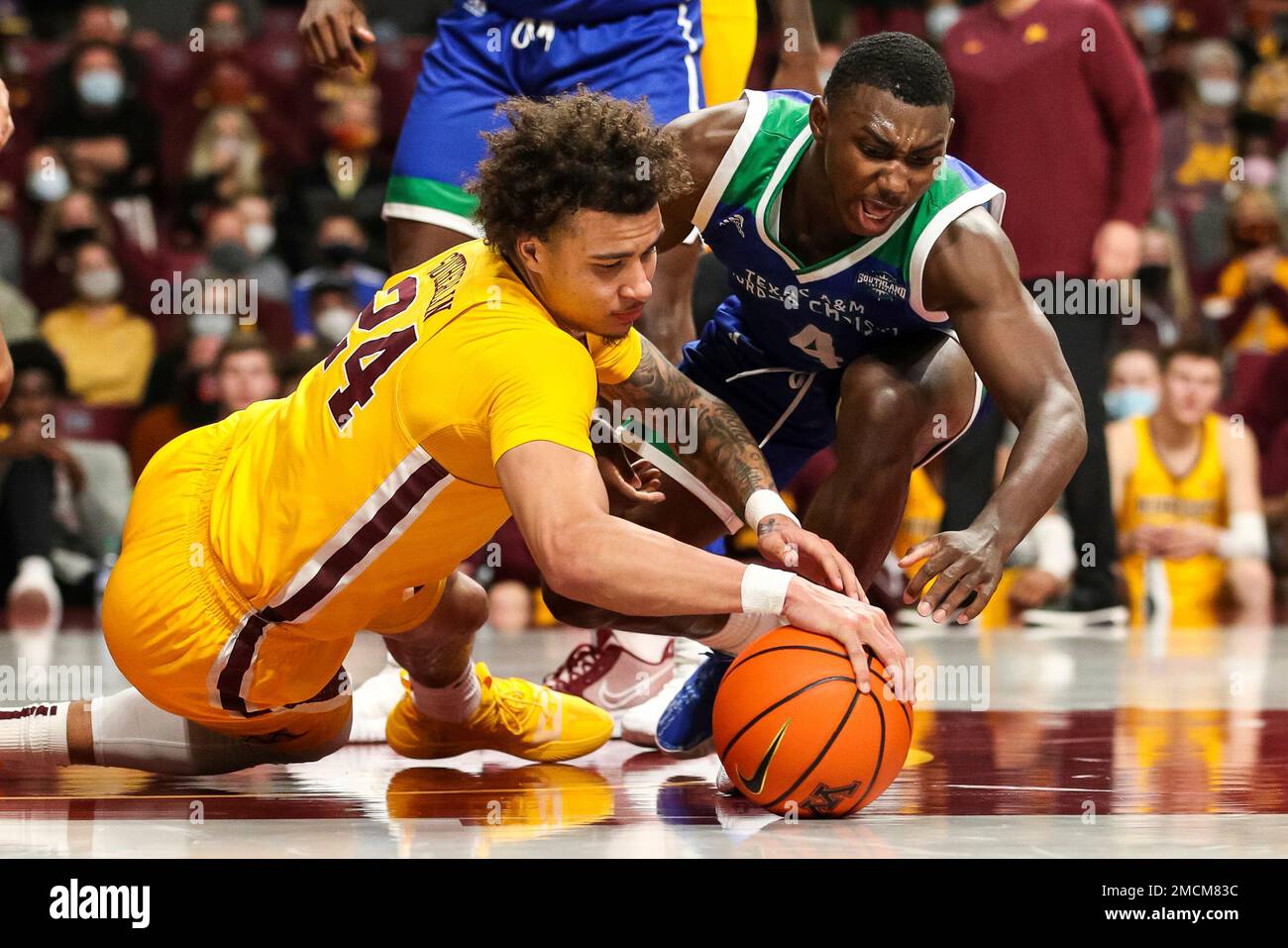 Minnesota guard Sean Sutherlin (24) and Texas A&M Corpus Christi guard ...