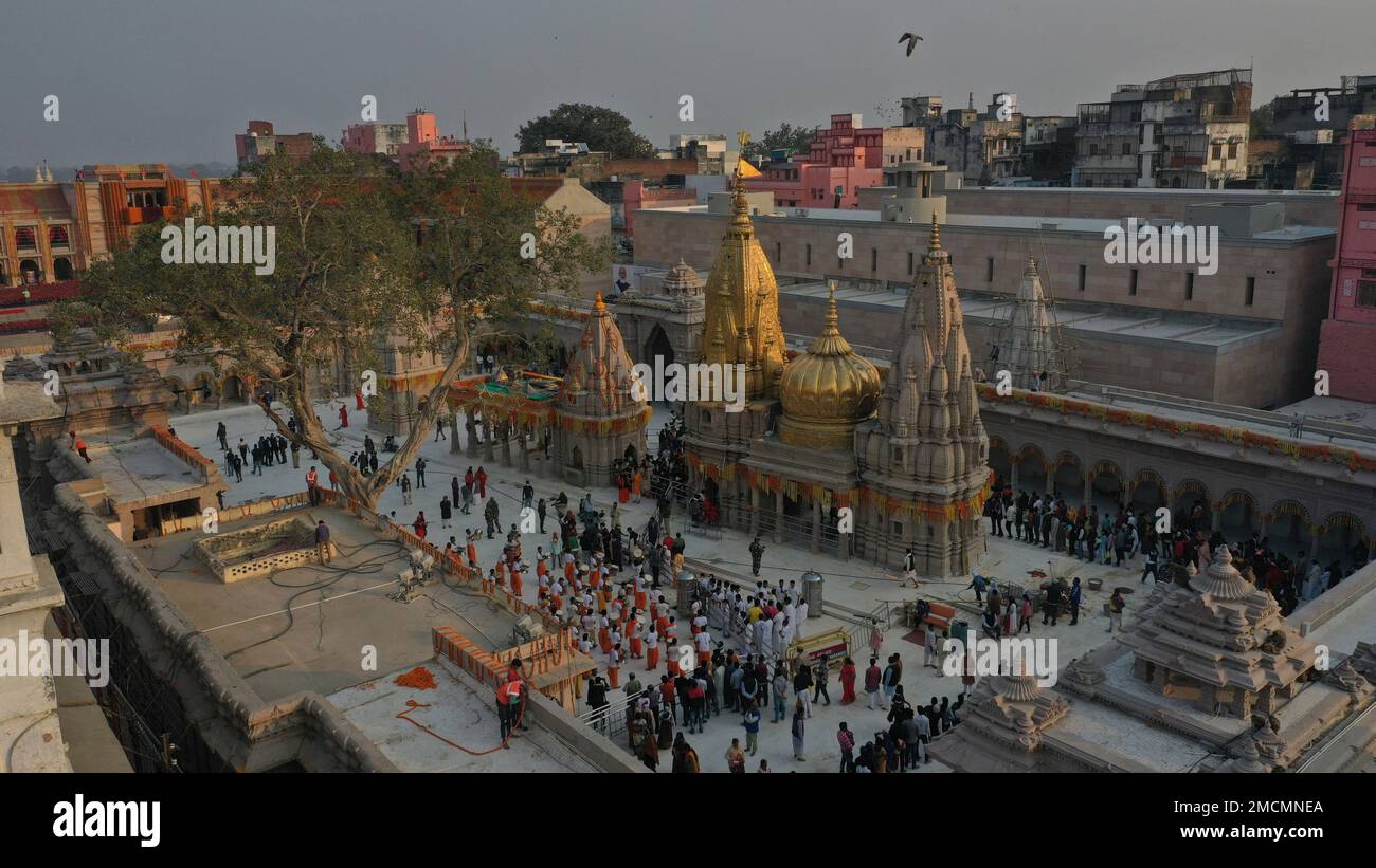 Devotees stand in queue to offer prayers at the Kashi Vishwanath temple dedicated to Lord Shiva ...