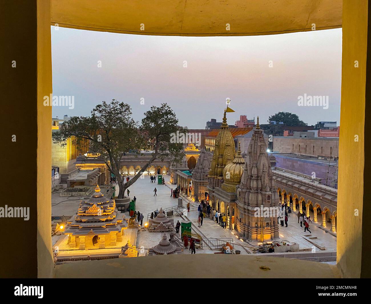 Devotees offering prayers at the Kashi Vishwanath temple are seen from a newly constructed ...