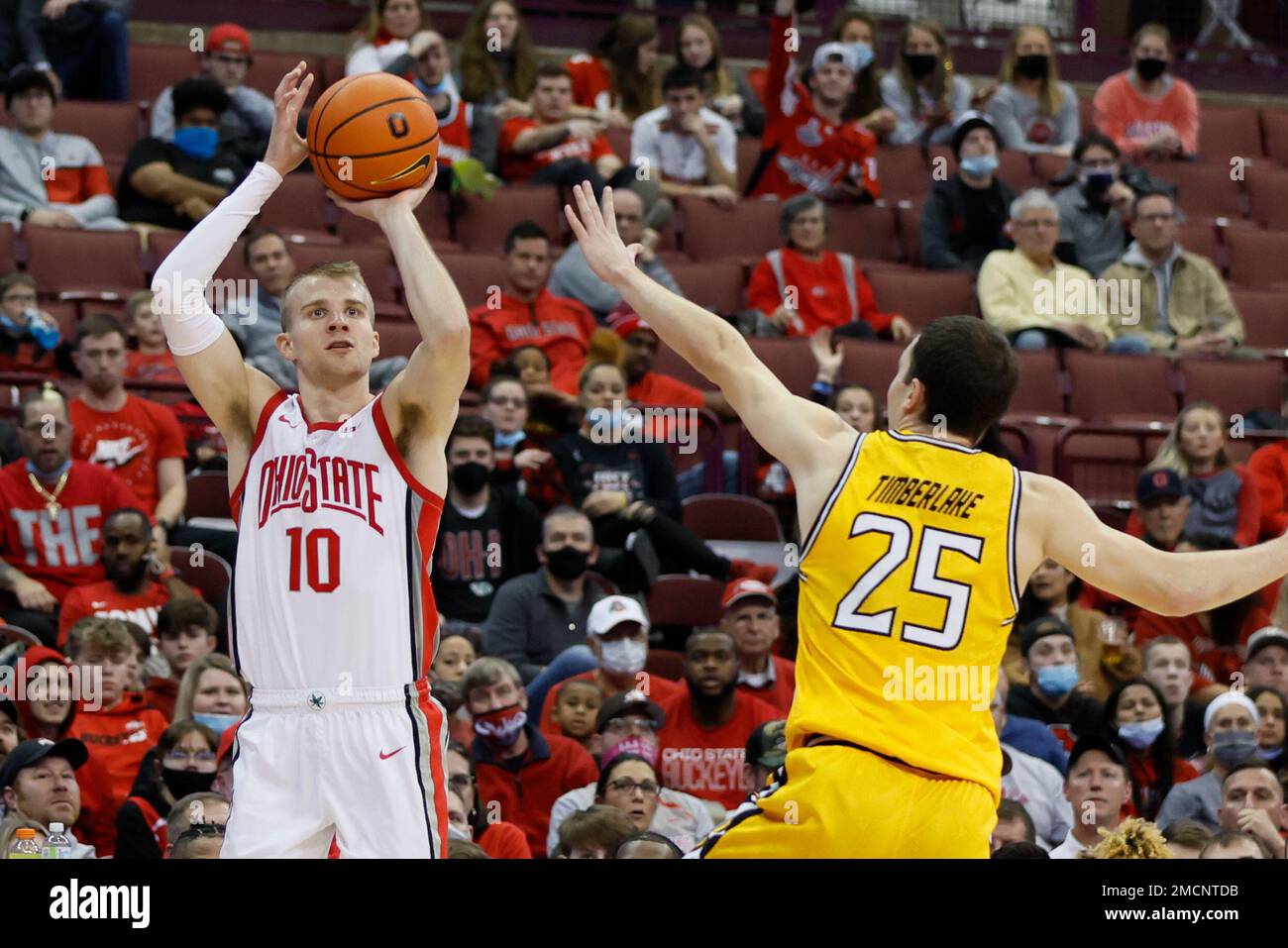 Ohio State's Justin Ahrens, left, shoots over Towson's Nicolas ...