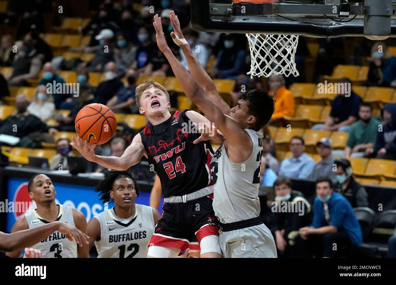 Eastern Washington guard Mason Landdeck, left, drives the lane as ...