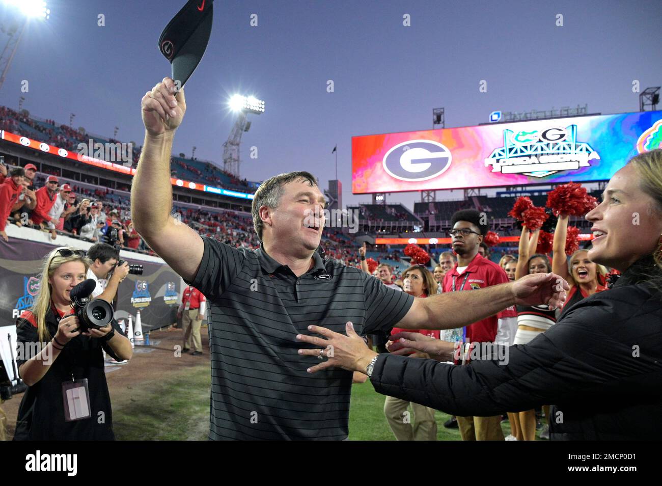 FILE - Georgia head coach Kirby Smart, center, is greeted by his wife ...