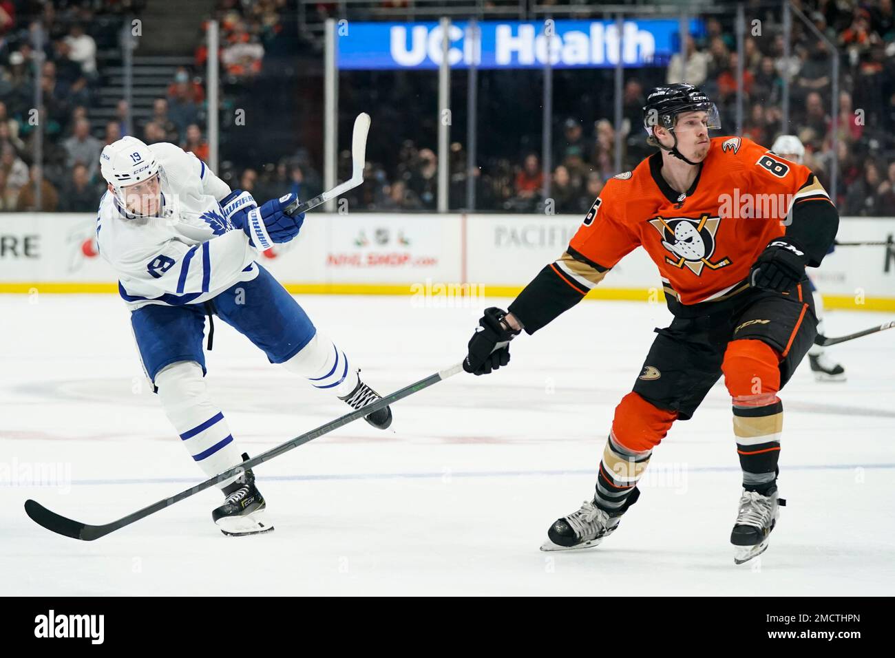 Anaheim Ducks' Simon Benoit, left, watches a shot by Toronto Maple ...