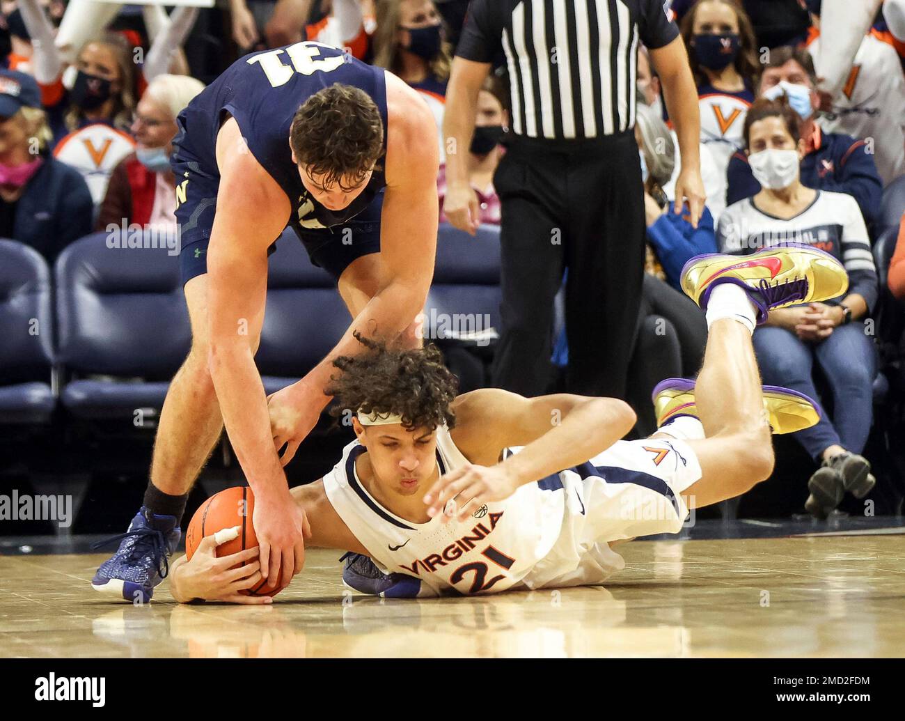 Navy forward Daniel Deaver (31) fights for a loose ball with Virginia ...