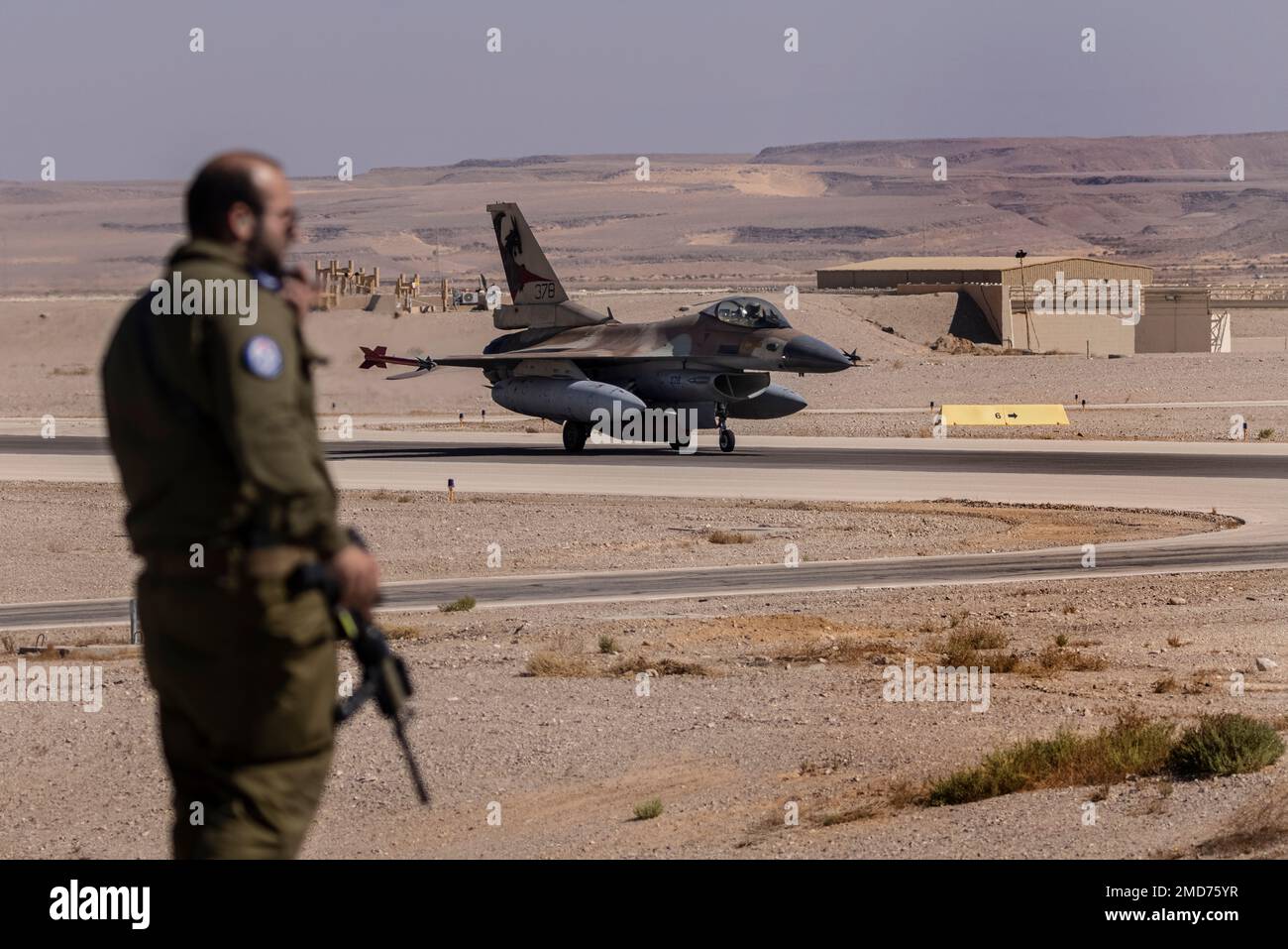 CORRECTS AIRPLANE TYPE TO F-16 NOT F-35 -An Israeli officer watches as ...