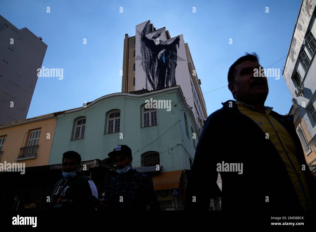 Pedestrians walk under "My World" an acrylic paint by visual artist Ino ...