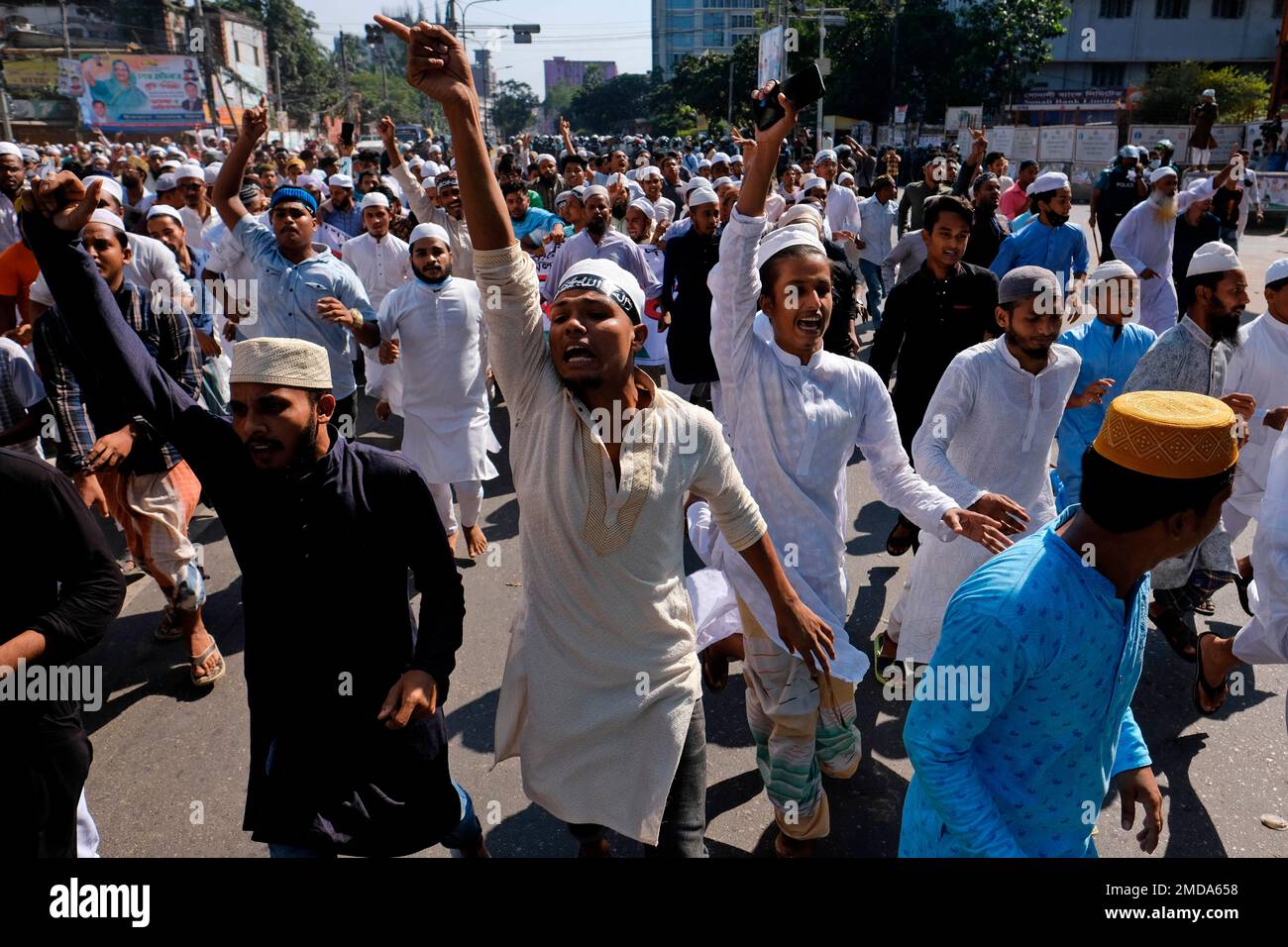 Muslim devotees shout slogans during a protest over an alleged insult ...