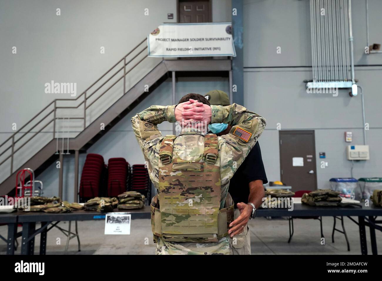 U.S. Army Staff Sgt. Brian Harris is fitted with body armor by Army ...
