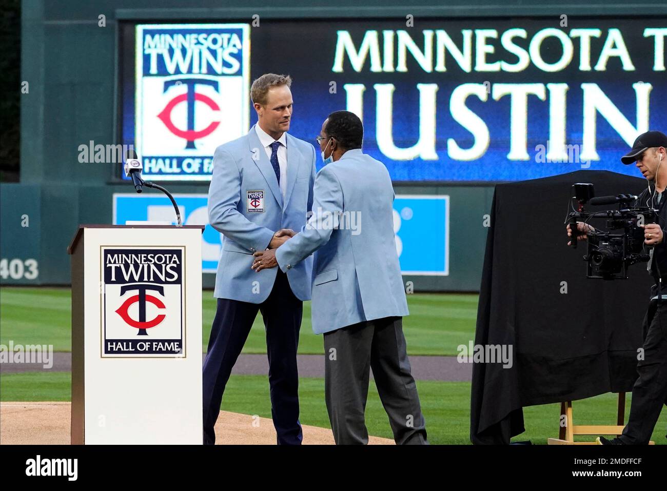 Former Minnesota Twins player Justin Morneau, left, shakes hands with ...