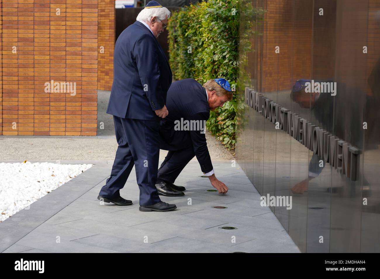 King Willem-Alexander puts a stone in an act of remembrance when ...