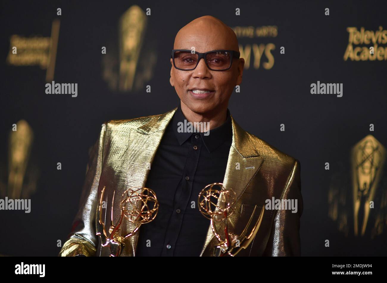 RuPaul poses with the award for outstanding host for a reality or ...