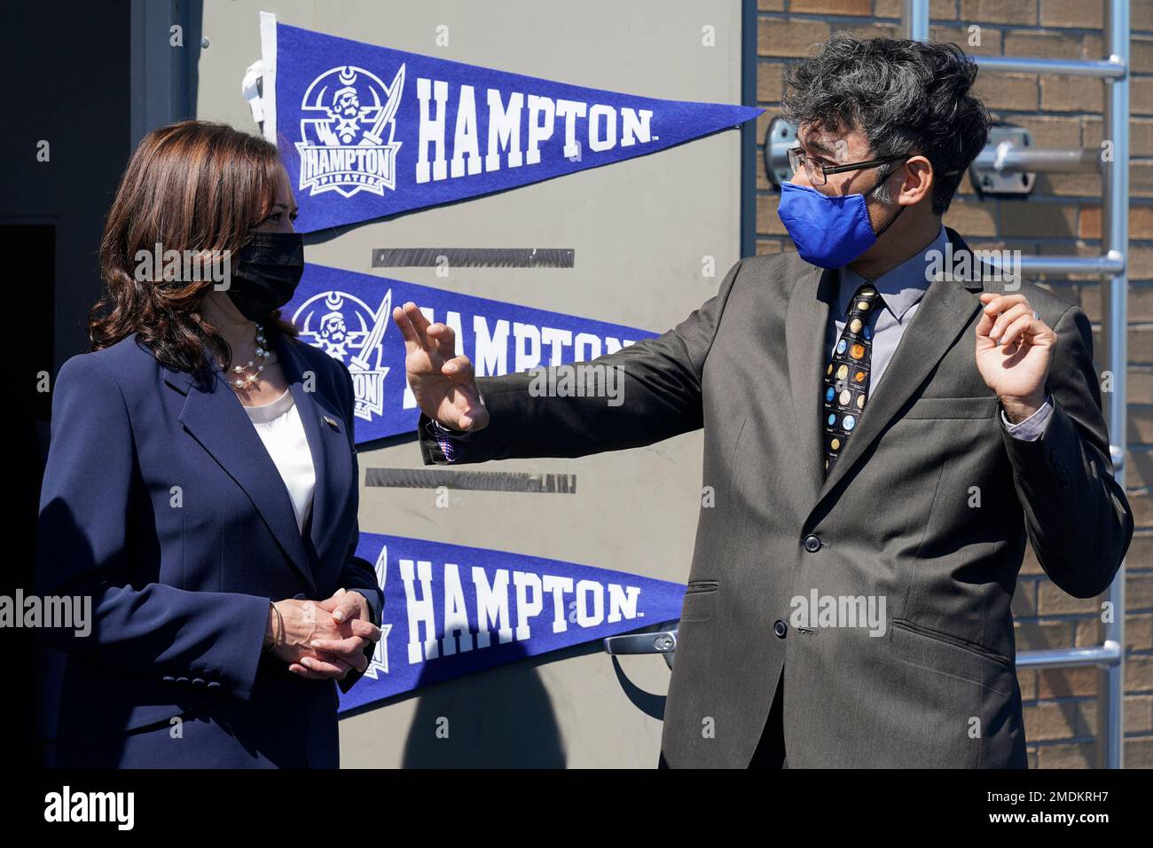 Vice President Kamala Harris, left, listens to professor Kunio Sayanagi ...