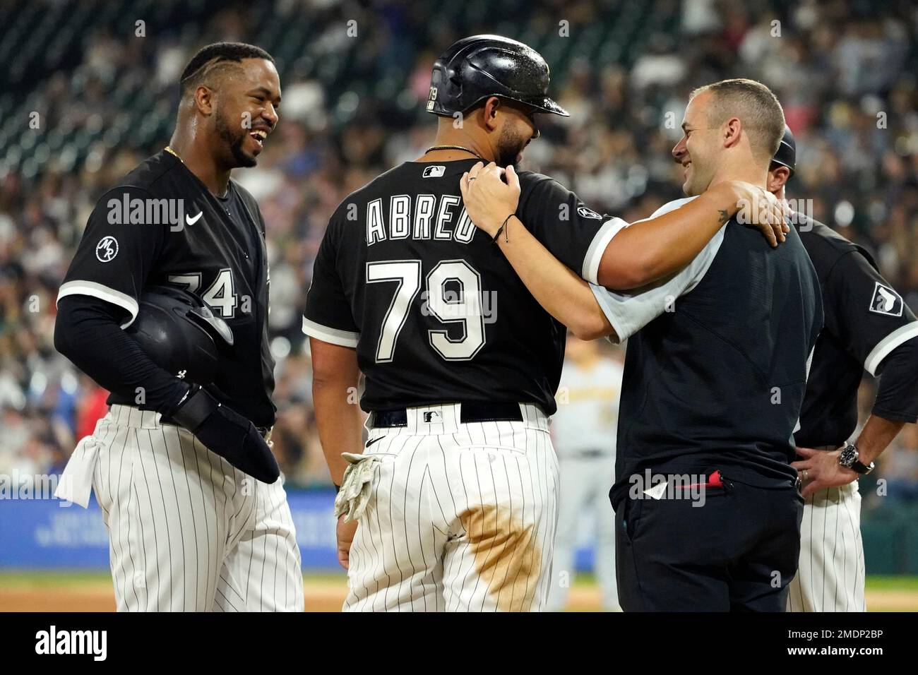 Chicago White Sox's Eloy Jimenez (74) and Jose Abreu (79) laugh with ...