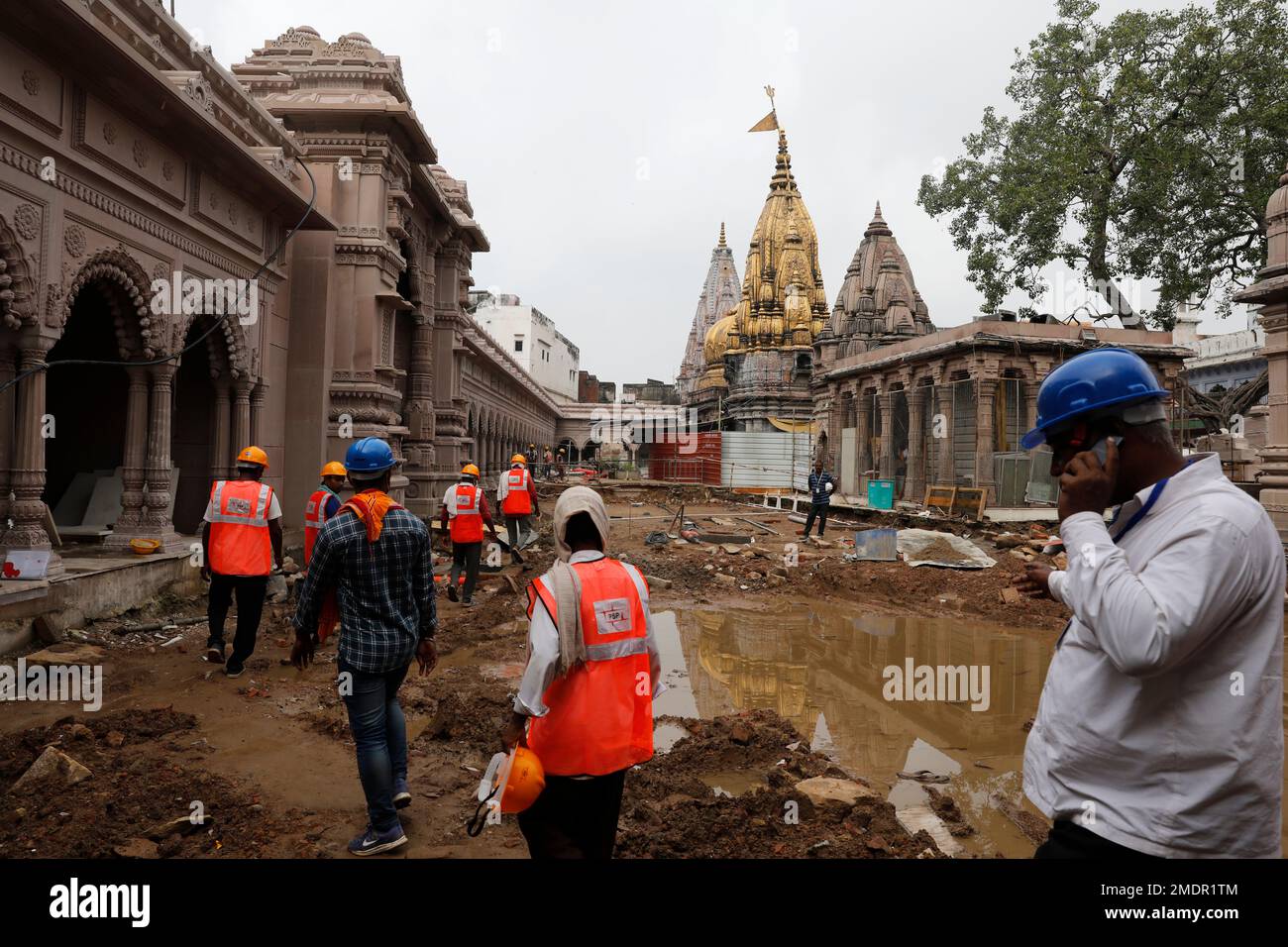 Laborers walk at the under-construction Kashi Vishwanath Dham Corridor project in Varanasi ...